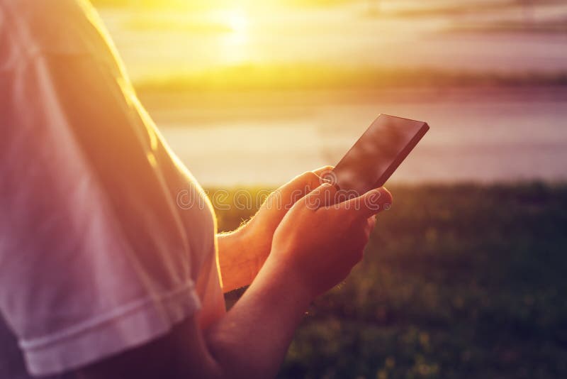 Hands Texting on Mobile Phone in Sunset Stock Image - Image of sunset ...