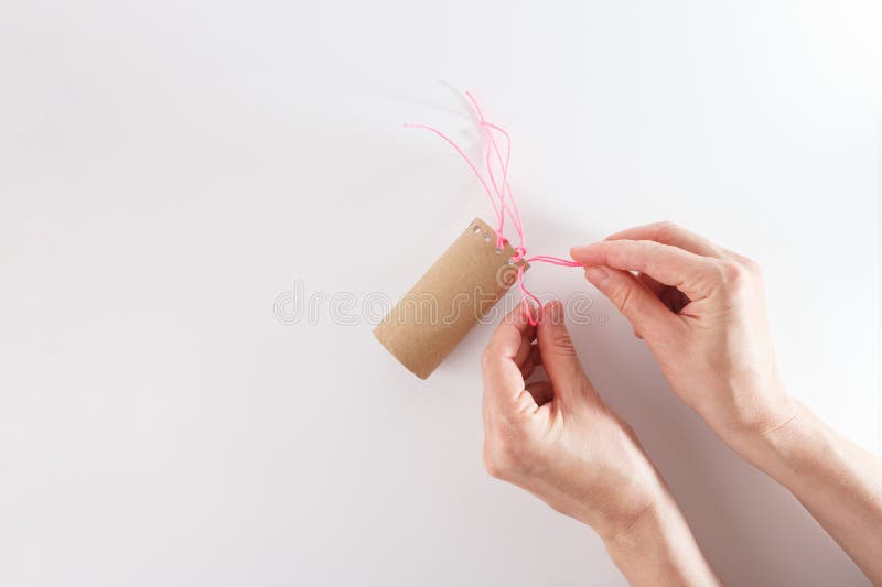 Hands Threading Yarn through Cardboard Tube during DIY Craft Step ...