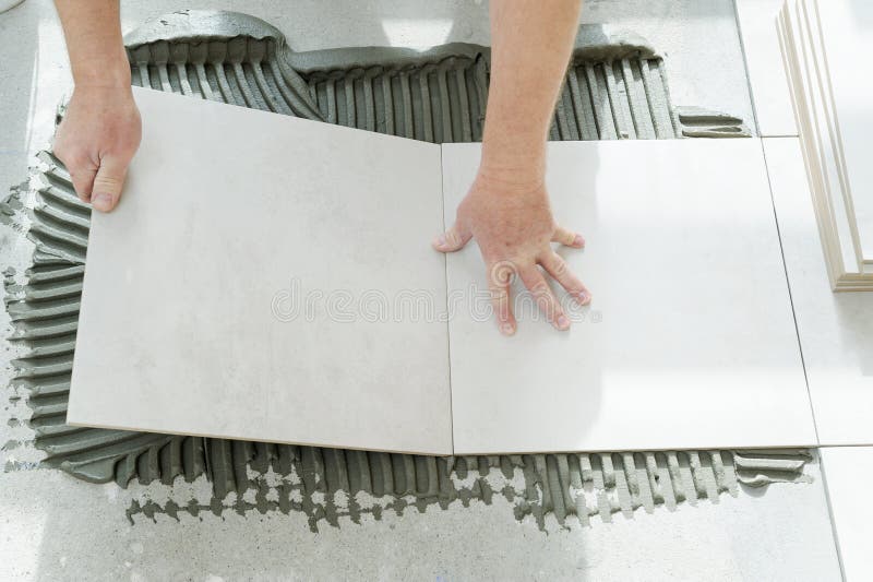 Laying Ceramic Tiles. stock photo. Image of tiler, building - 99388246