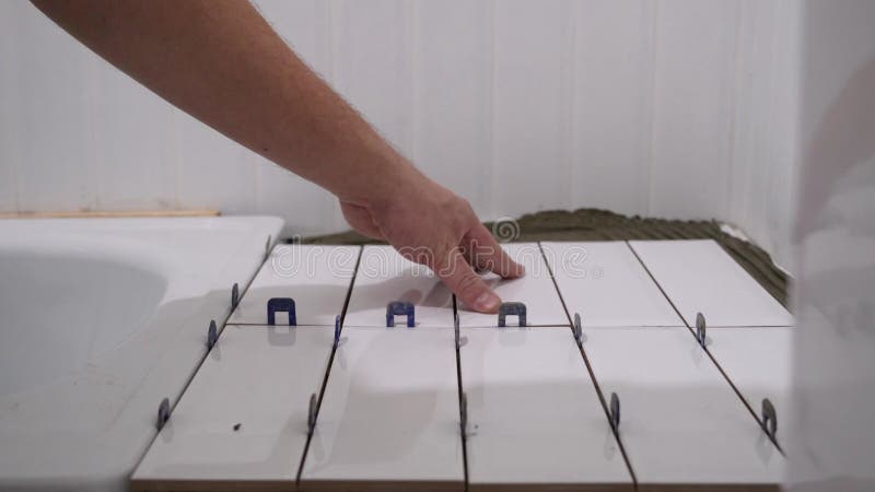 The Hands of the Tiler are Laying the Ceramic Tile on the Wall Stock ...
