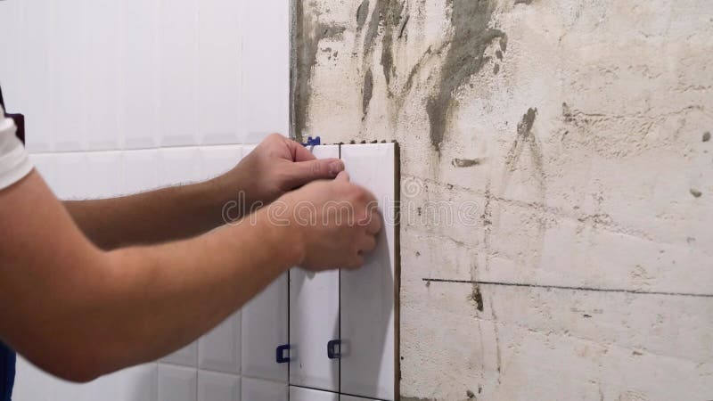 The Hands of the Tiler are Laying the Ceramic Tile on the Wall Stock ...