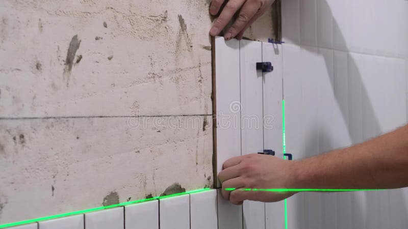 The Hands of the Tiler are Laying the Ceramic Tile on the Wall Stock ...