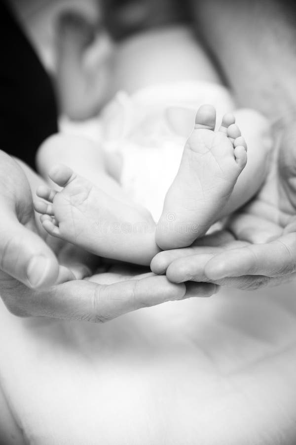 Hands touch child s feet stock image. Image of feeding - 19509263