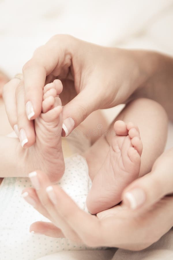 Hands touch child s feet stock image. Image of love, white - 19509295