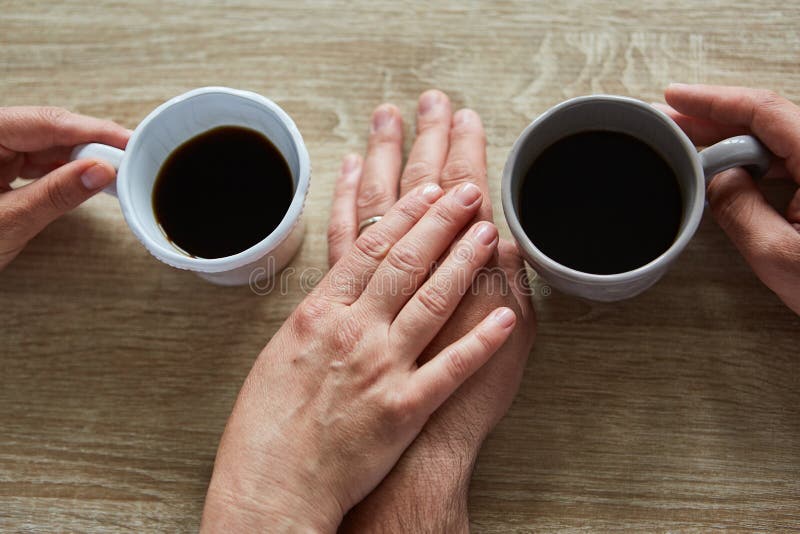 Hands Touch while Drinking Coffee from Above Stock Image - Image of ...