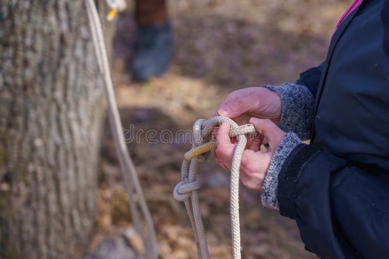 Hands of a Tourist Tying Knots on a Rope with Selective Focus ...