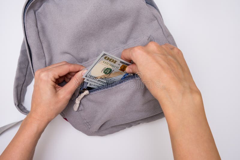 Hands of a Traveller Putting Money Dollars in a Pocket of a Backpack ...