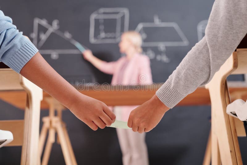 Hands of Two Schoolkids Passing Each Other Small Notepaper with Right ...