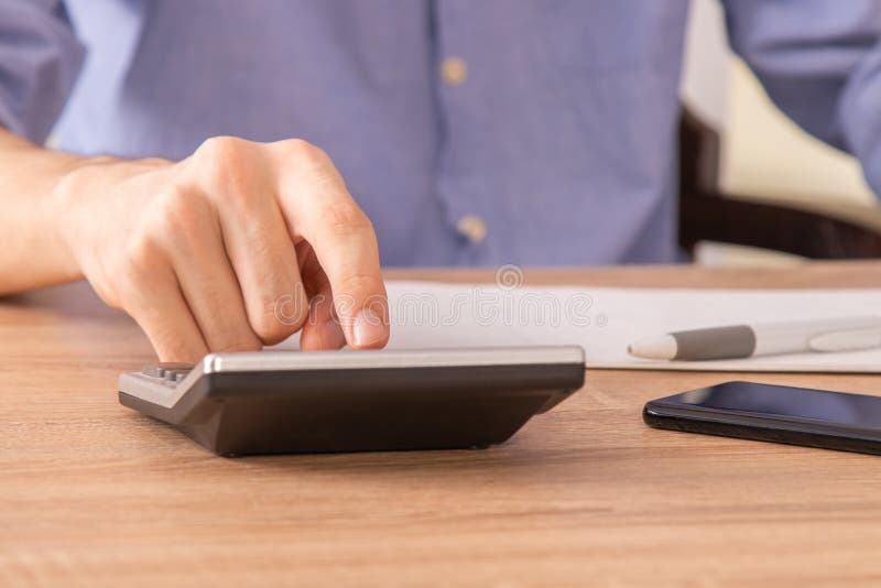 Hands typing calculator stock photo. Image of paperwork - 191115646