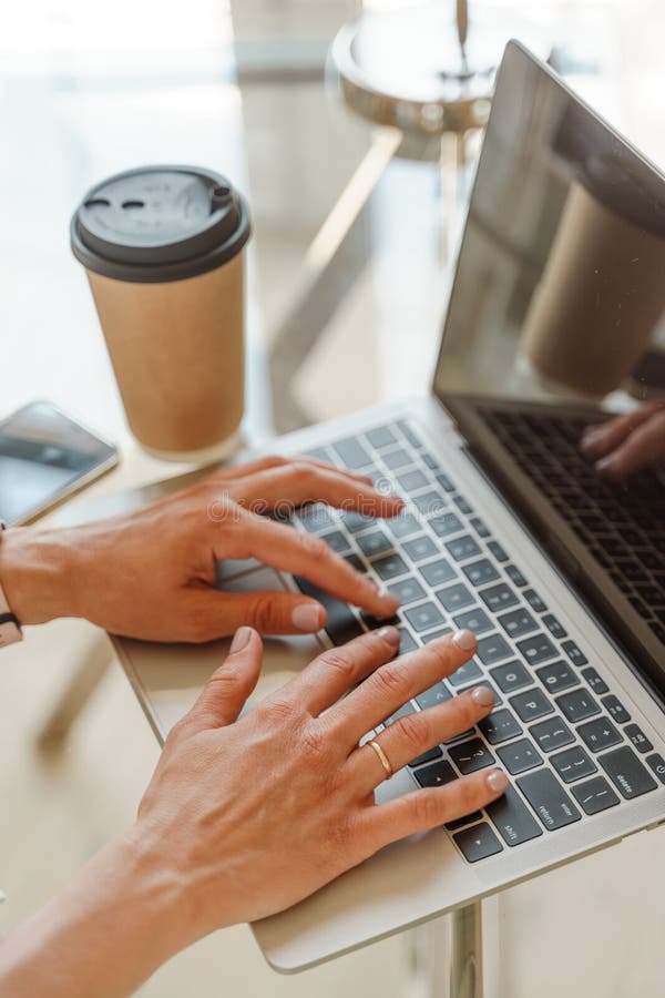 Hands Typing on a Computer Keyboard Over a White Office Table with a ...