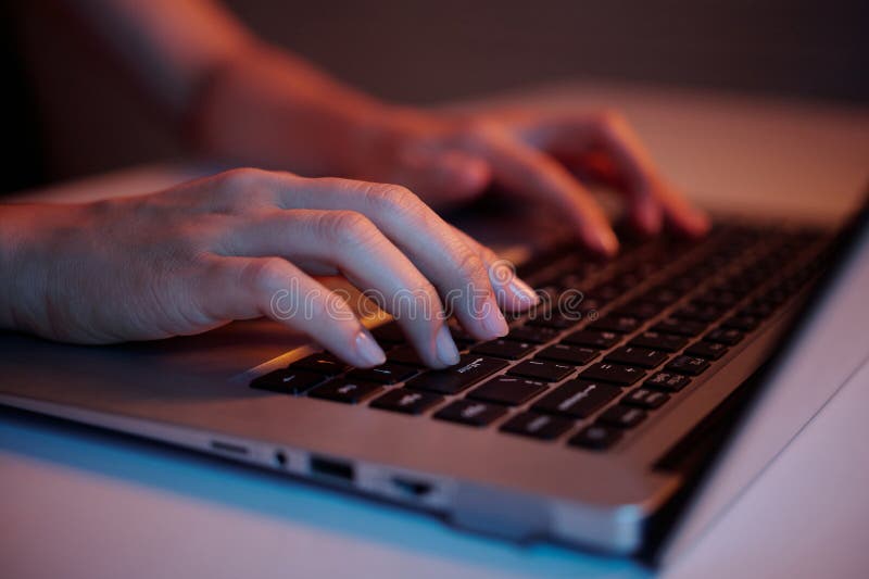 Hands Typing on Laptop Keyboard in Dim Light Stock Photo - Image of ...