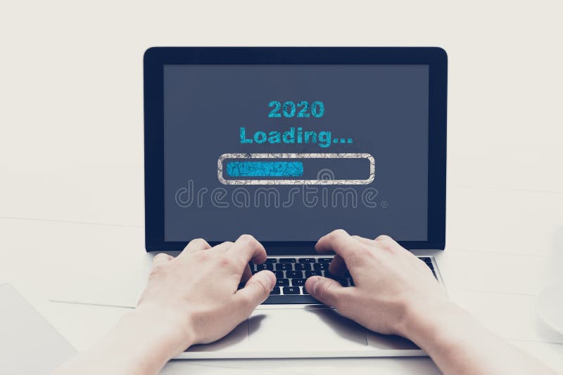 Hands Typing on a Laptop Keyboard. 2020 is Loading on the Screen Stock ...