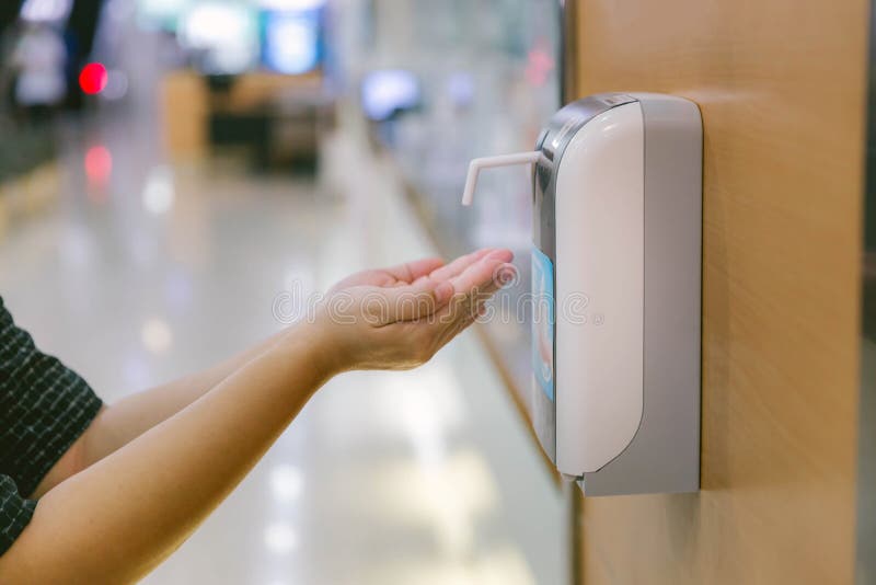 Hands Under the Automatic Alcohol Dispenser. Infection and Hospitably ...