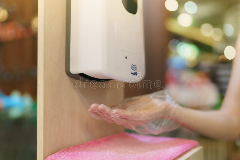 Hands Under the Automatic Alcohol Dispenser To Avoid the Spread of ...