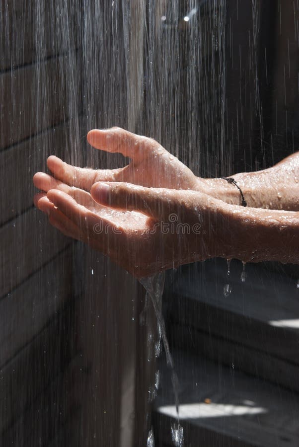 Hands Under Falling Water stock image. Image of brown - 8062959