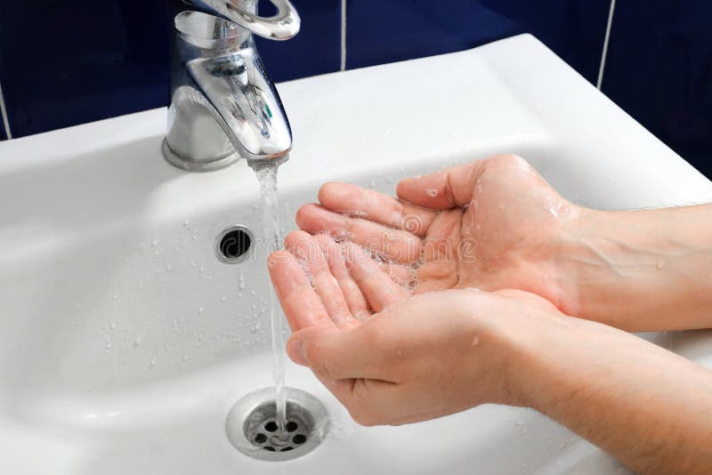 Hands Under the Tap with Water Over the Sink in the Bathroom. Hygiene ...