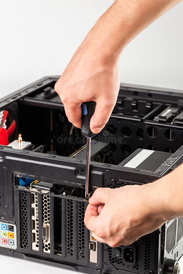 Hands Unscrewing a Video Card Bracket while Maintenance Personal ...