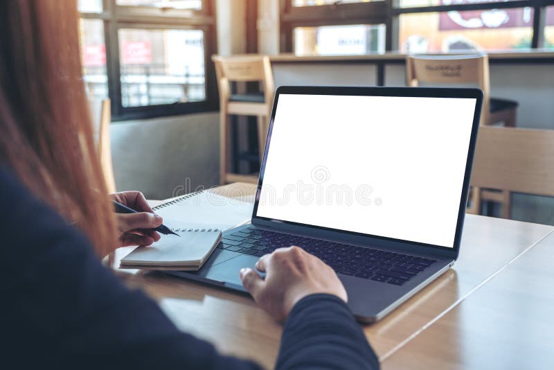 Hands Using Laptop with Blank White Desktop Screen while Writing on a ...
