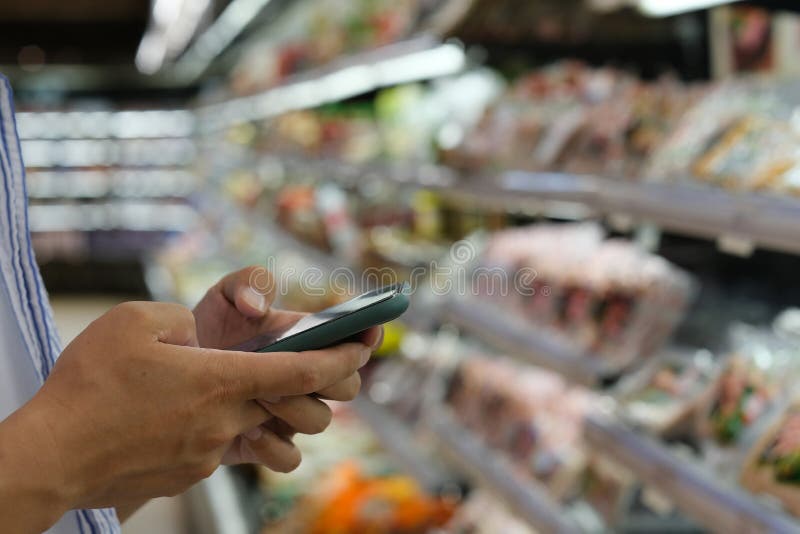 Hands Using Smart Phone at Grocery Store Stock Photo - Image of ...
