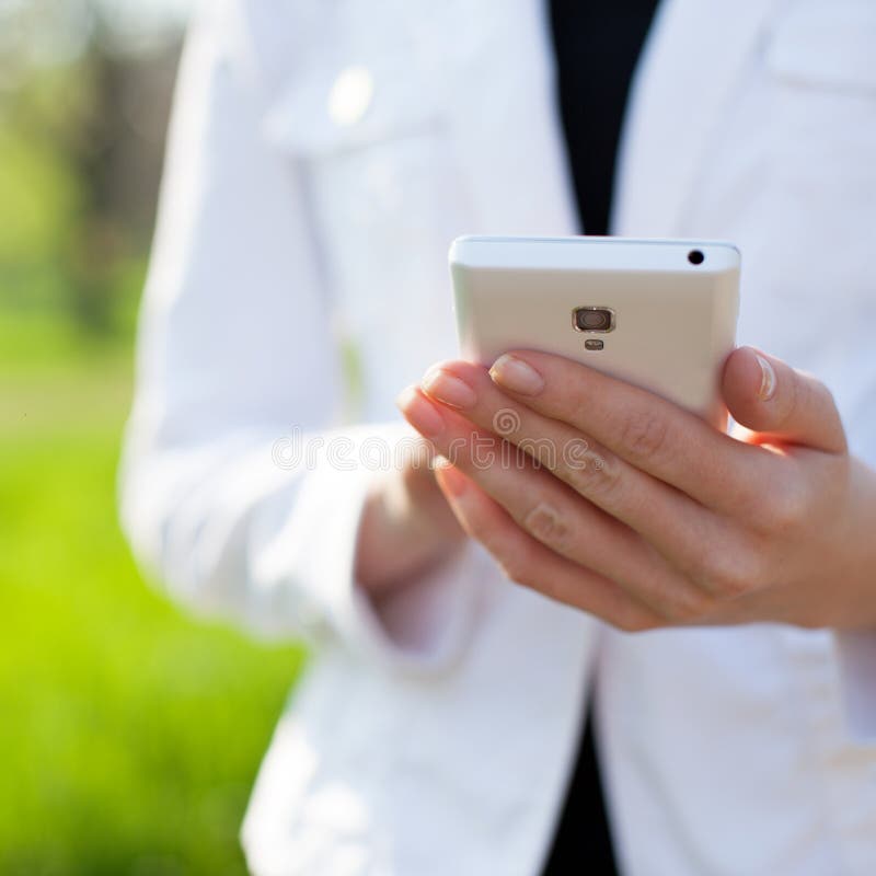 Hands using smartphone stock photo. Image of grass, park - 40052878