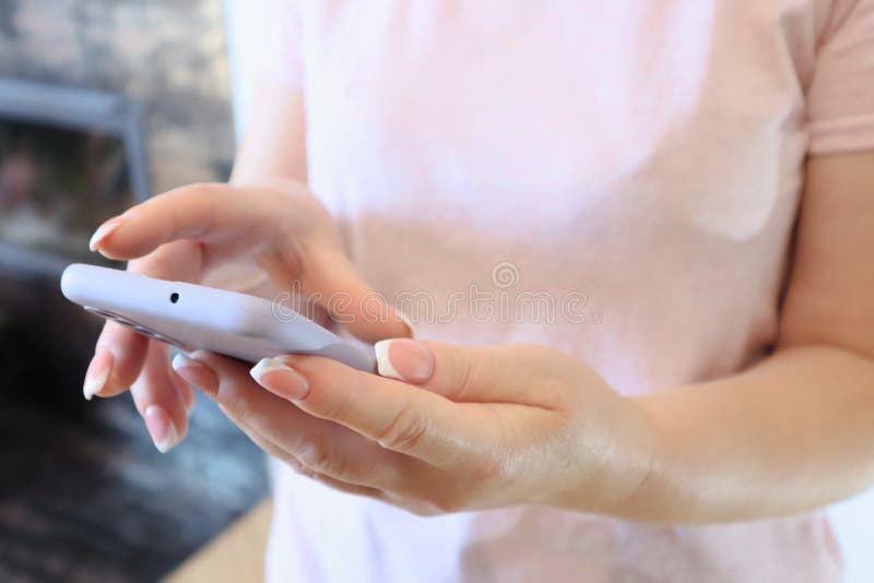 Hands Using a Smartphone. Midsection of Woman Using Mobile Phone at ...