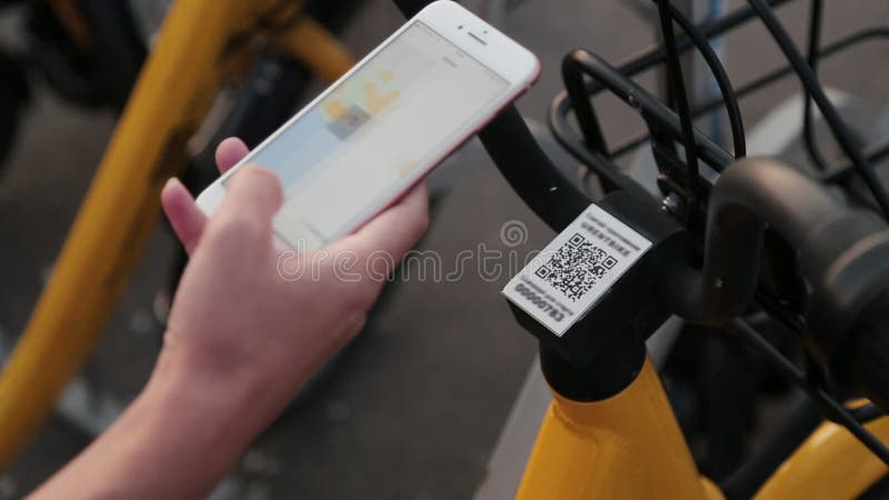 Hands Using Smartphone Scanning the QR Code of Shared Bike in City ...