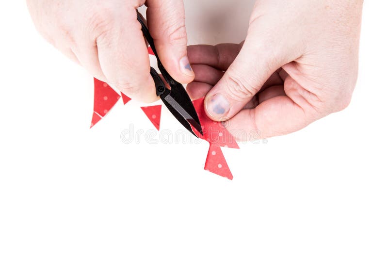 Hands Using Snipper Tool To Cut Pattern Out of Red Paper Stock Image ...