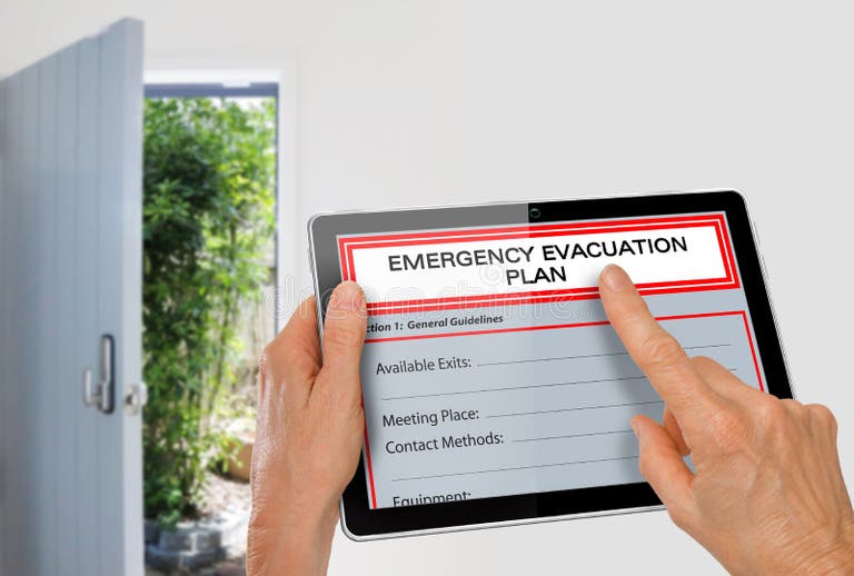 Hands Using Tablet with Emergency Evacuation Plan beside Exit Door ...