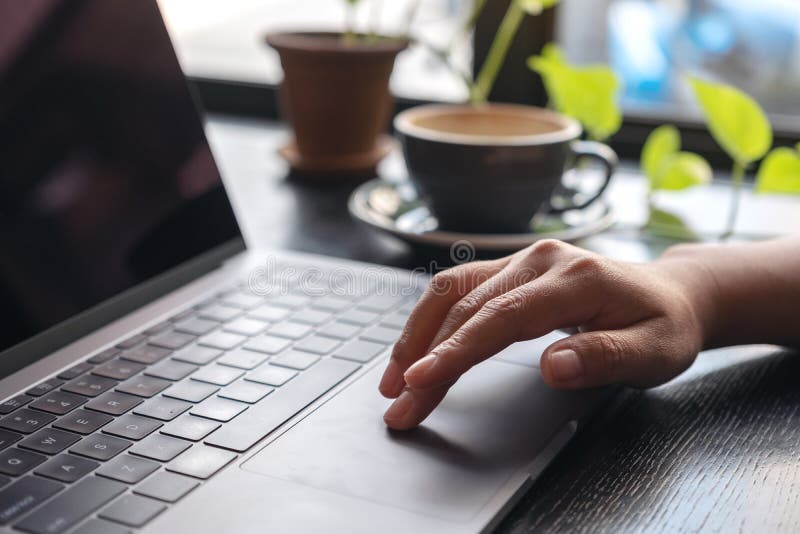 Hands Using and Touching on Laptop Touchpad with Coffee Cup on Wooden ...