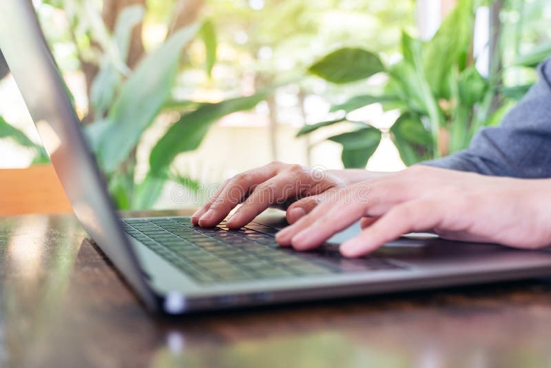 Hands Using and Typing on Laptop Computer Keyboard on the Table Stock ...