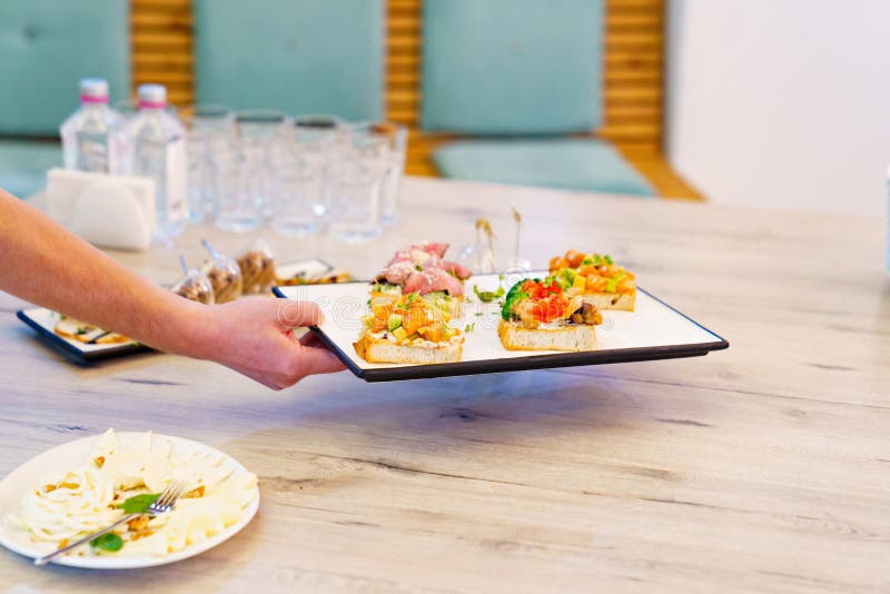 Hands of a Waiter with a Plate. Catering for the Holiday. Buffet Menu ...