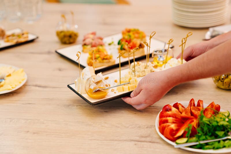 Hands of a Waiter with a Plate. Catering for the Holiday. Buffet Menu ...