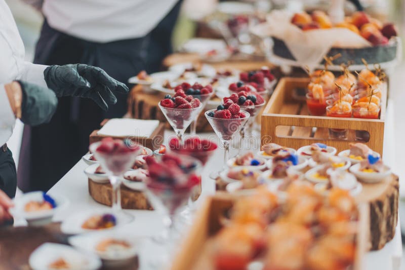 Hands of a Waiter Prepare Food for a Buffet Table in a Restaurant ...