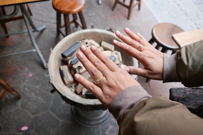 Hands Warming by a Traditional Fire Pit in a Cozy Setting Stock Photo ...