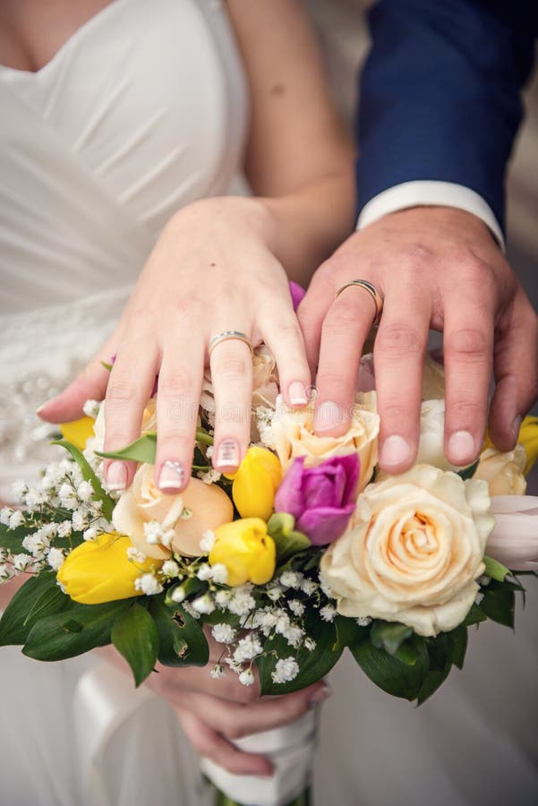 Hands with Wedding Rings and Bouquet Stock Image - Image of hands ...