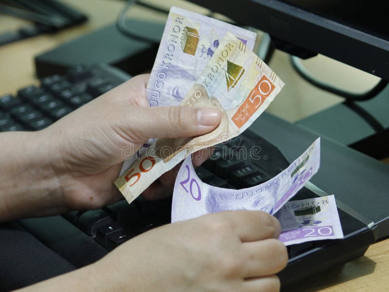 Hands of a Woman Counting Swedish Money on a Computer Keyboard Stock ...