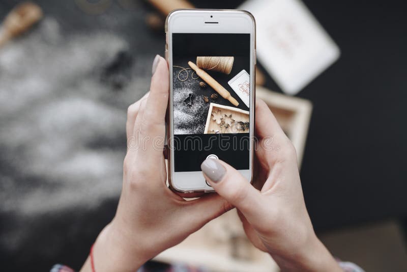 Hands of Woman Holding Phone in Kitchen Above Table Stock Image - Image ...