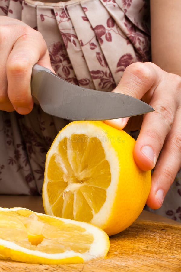 Slicing Lemon on the Cutting Board with Knife Stock Image - Image of ...