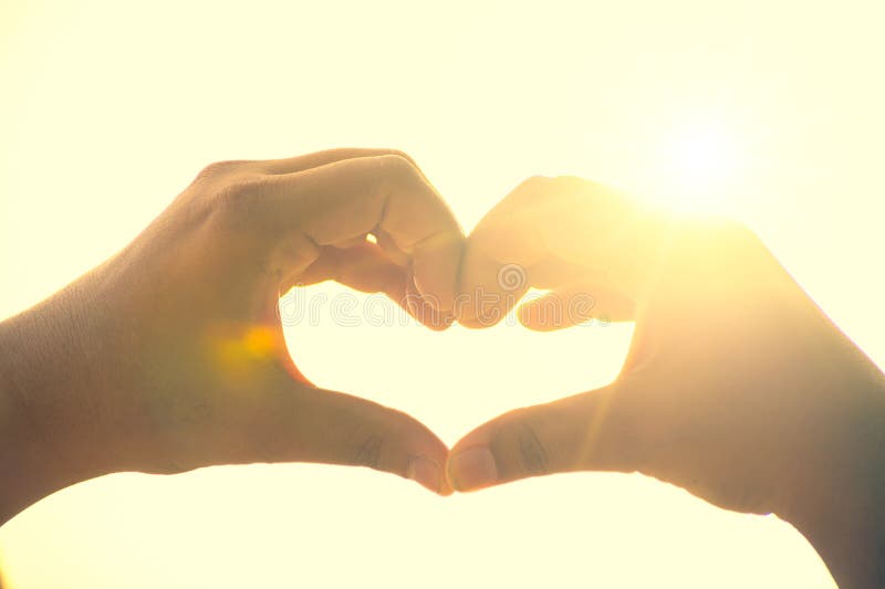 The Hands of Women and Men are the Heart Shape with the Sun Light ...