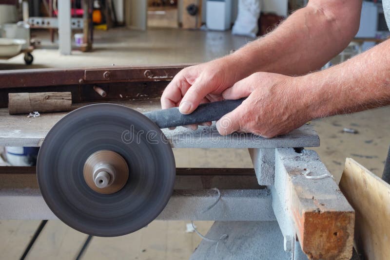 Hands of Worker Wich is Sharpering Knife on Grindstone Stock Photo ...