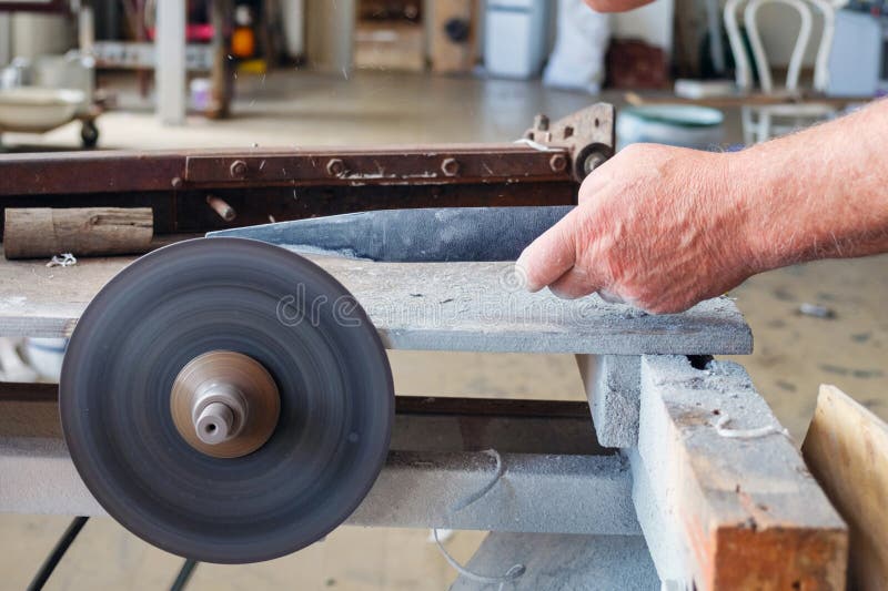 Hands of Worker Wich is Sharpering Knife on Grindstone Stock Image ...