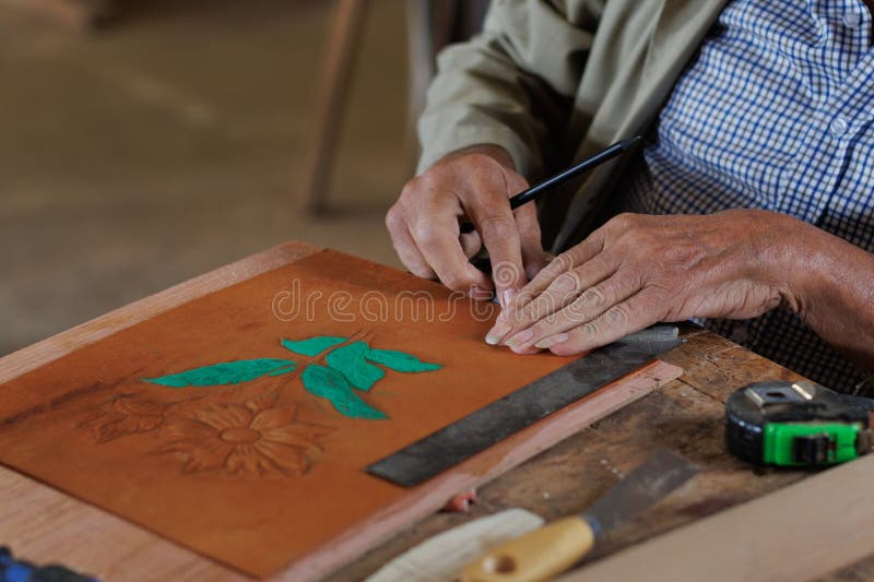 Hands of an Older Man, Working on Embossed Leather, and Taking Notes ...