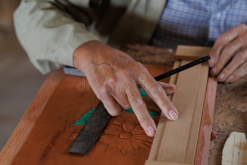 Hands of an Older Man, Working on Embossed Leather, and Taking Notes ...
