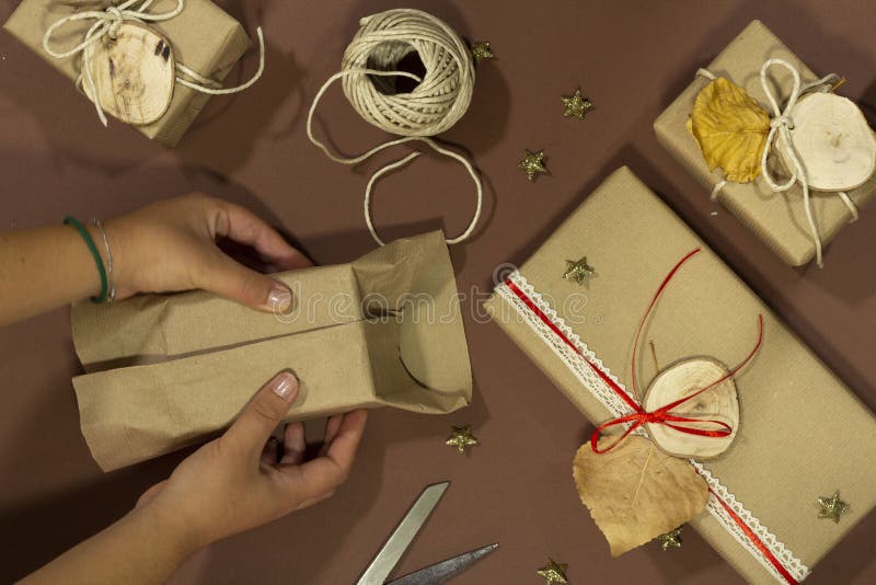 Hands wrapping a gift. stock photo. Image of yellow - 198491326