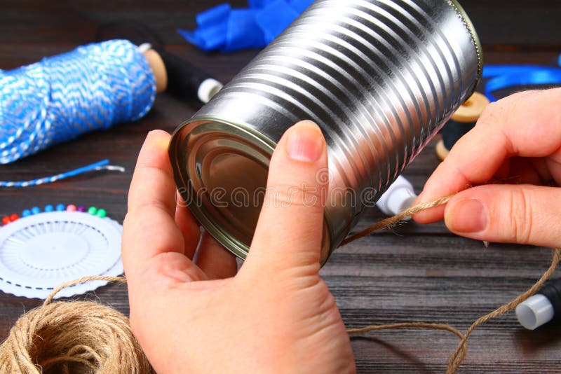 Hands Wrapping an Iron Jar with a String on a Wooden Table. Hand Stock ...