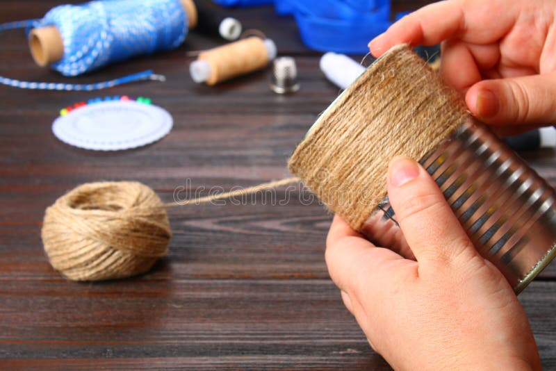 Hands Wrapping an Iron Jar with a String on a Wooden Table. Hand Stock ...