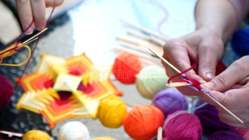 Hands are Wrapping Thread Around the Sticks Which are Held in a Cross ...