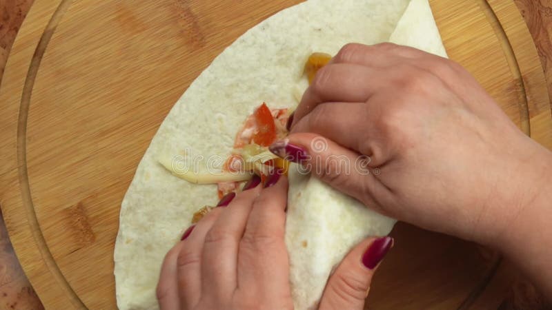 Hands Wrapping a Tortilla in an Envelope with Stuffing Stock Video ...
