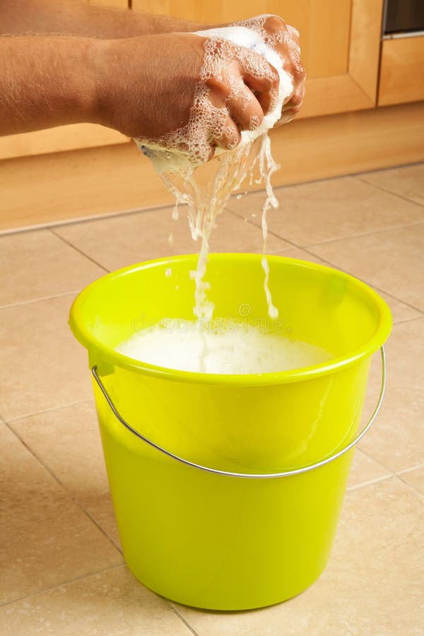 Wringing the Water Out of a Sponge on White Stock Image - Image of ...