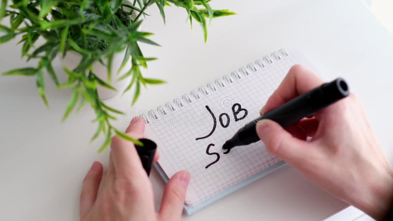 Hands Writing on a Notepad with a Marker Job Search on the Background ...